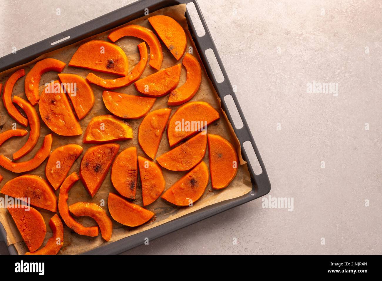 Chopped baked sweet butternut pumpkin on a baking sheet, top view Stock ...