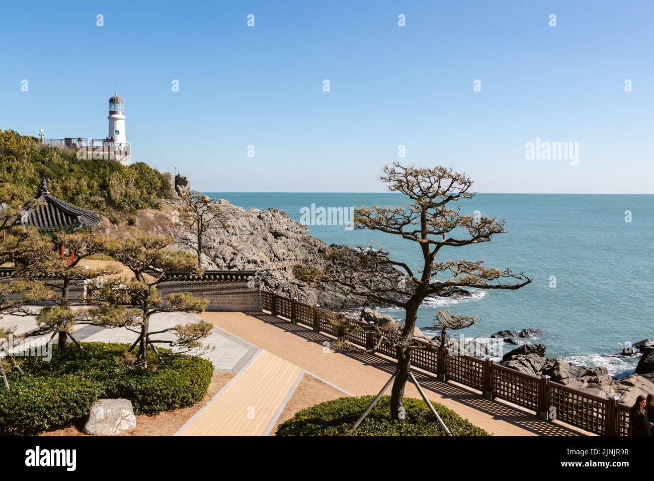 A mesmerizing landscape view with a white lighthouse in Busan South ...