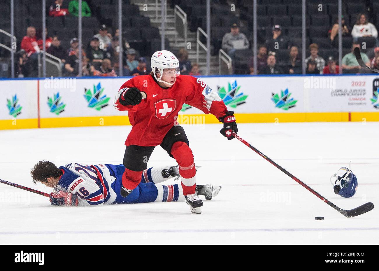 USA's Dominic James (16) is knocked off the puck as Switzerland's ...