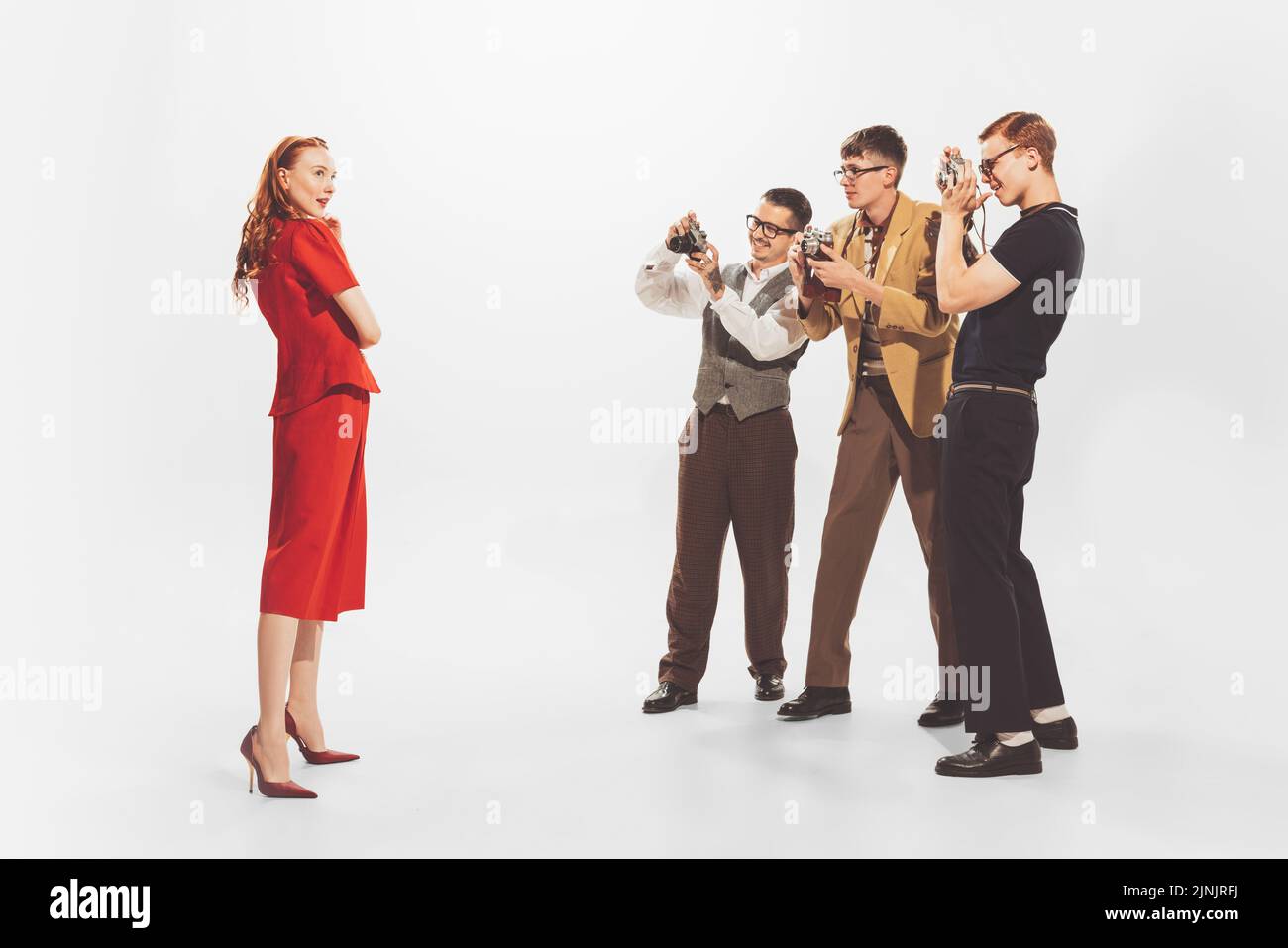 Group of young men in stylish suits taking photo of beautiful woman in ...