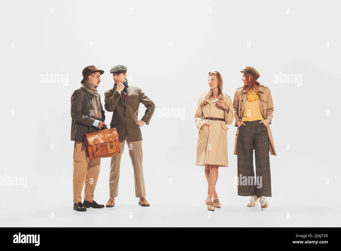 Group of stylish people in autumn outift, jackets and coats posing ...