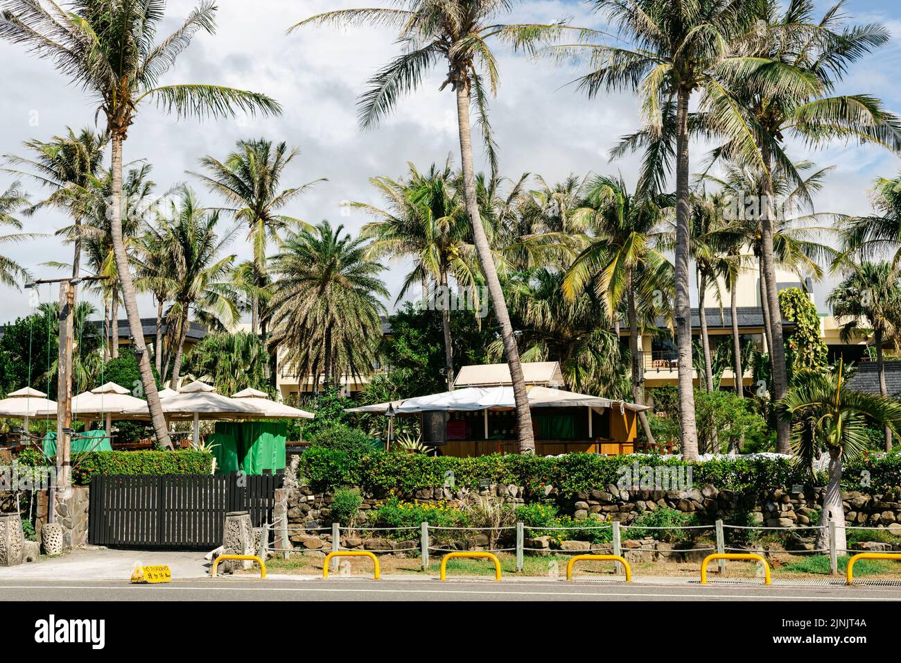 A buildings surrounded by palm trees at Kenting national park in Taiwan ...