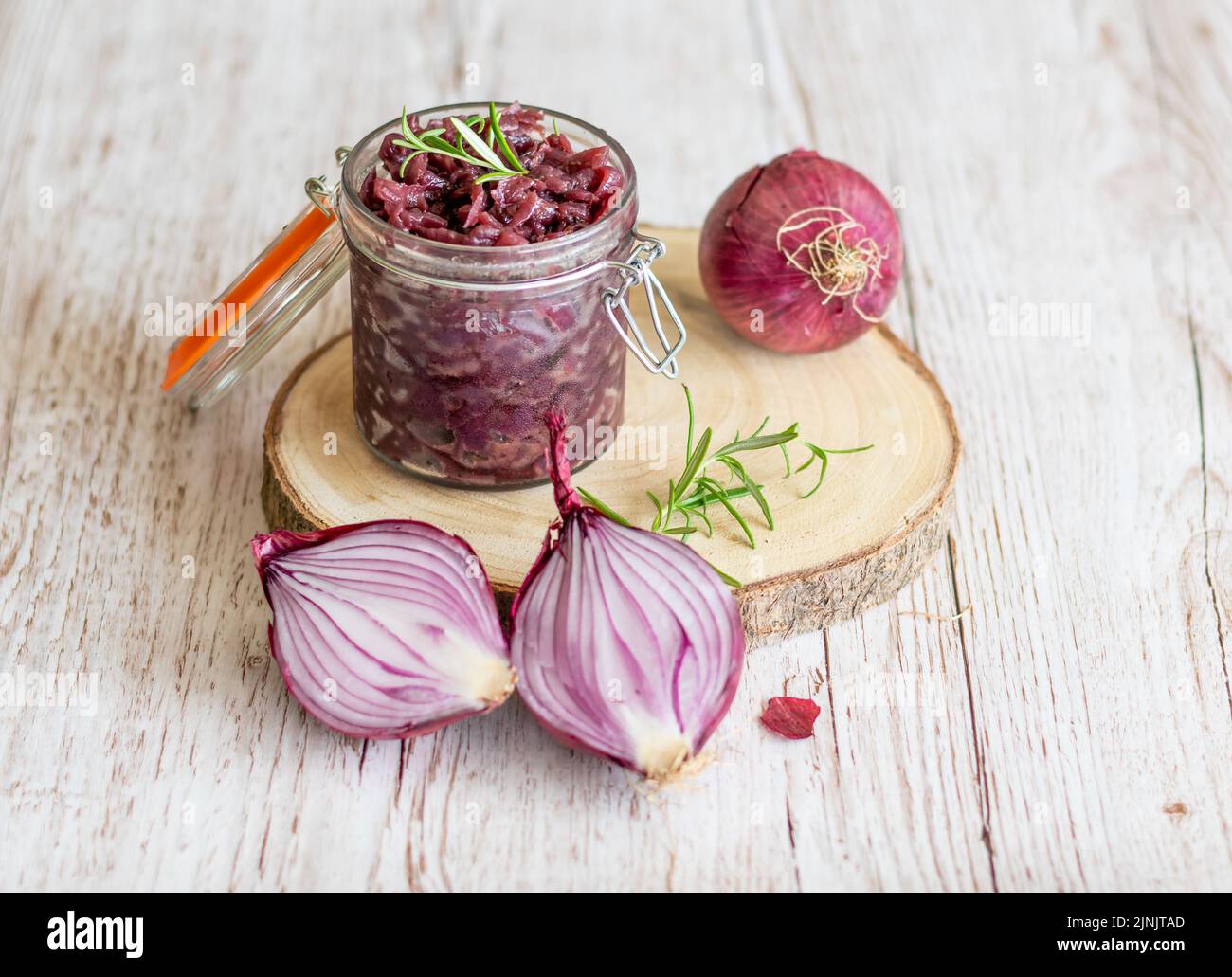 Red onion marmalade placed on wooden trunk with wood texture background ...