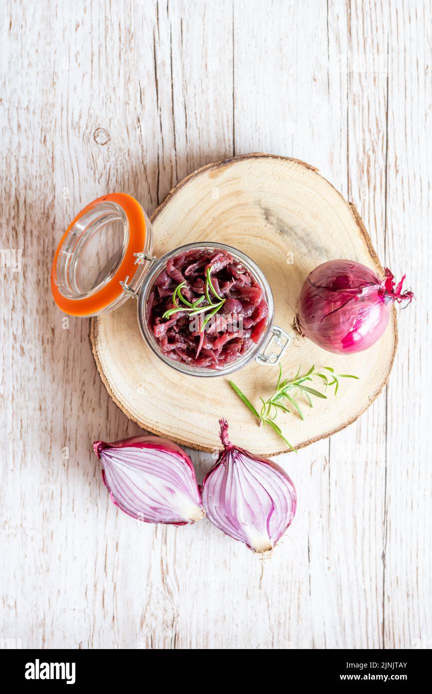 Red onion marmalade placed on wooden trunk with wood texture background ...