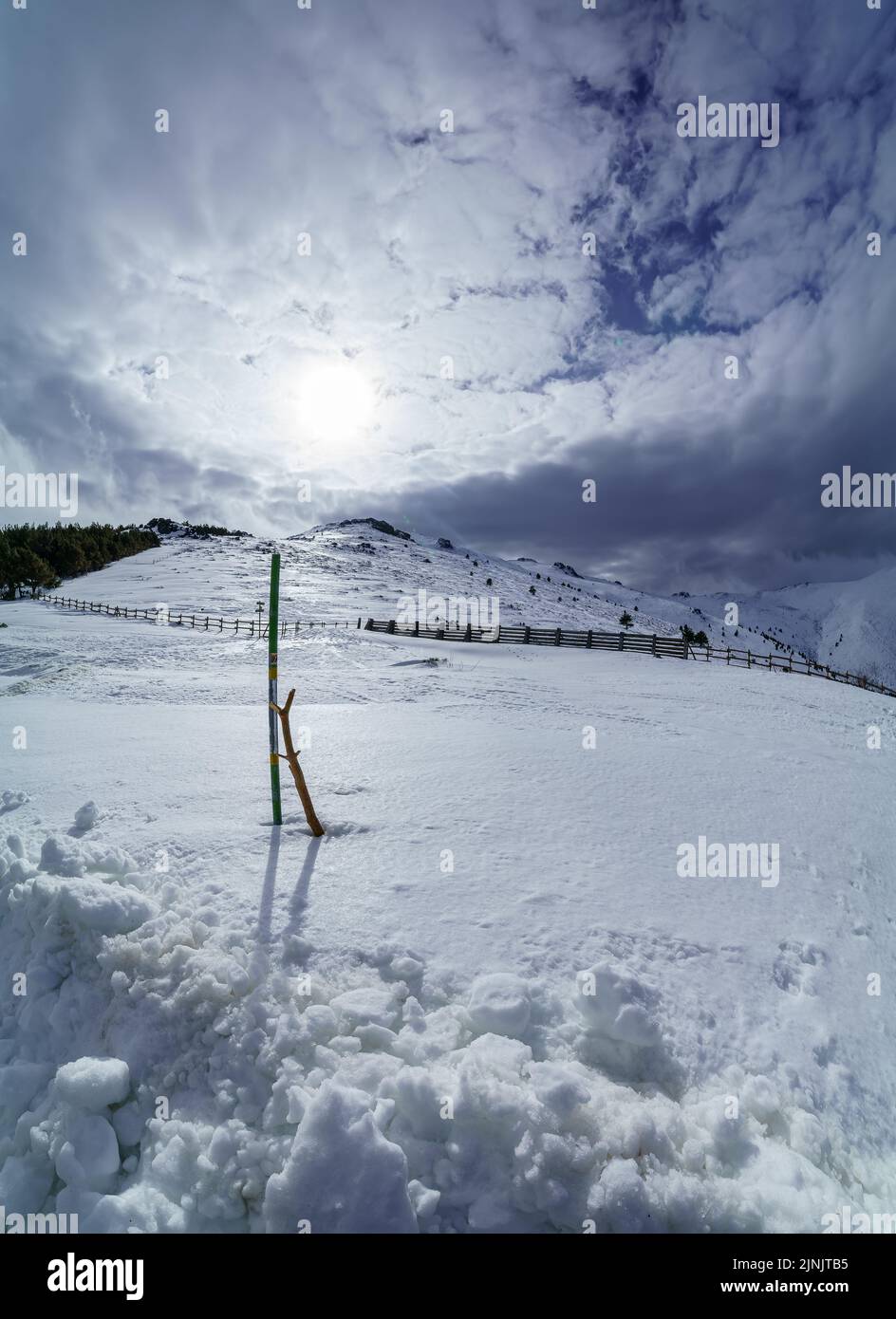 Vertical panoramic of snowy high mountain landscape with sunrise sun ...