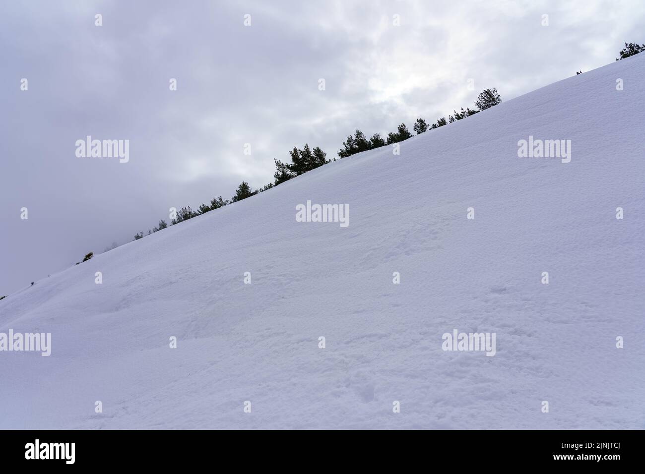 snow-covered mountain slope with clouds. Snow texture Stock Photo - Alamy