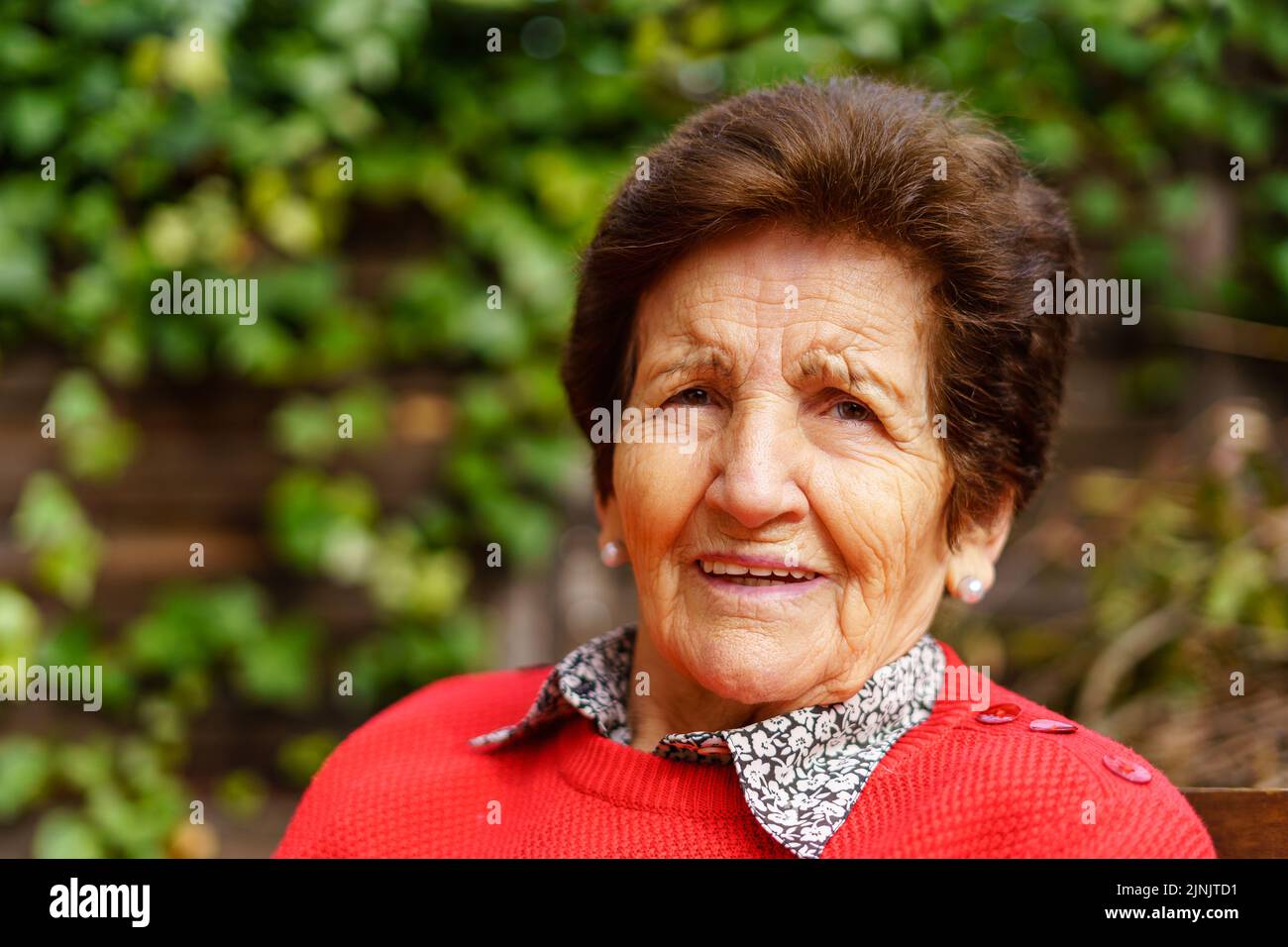 90 year old senior woman in the garden and laughing joyfully Stock ...