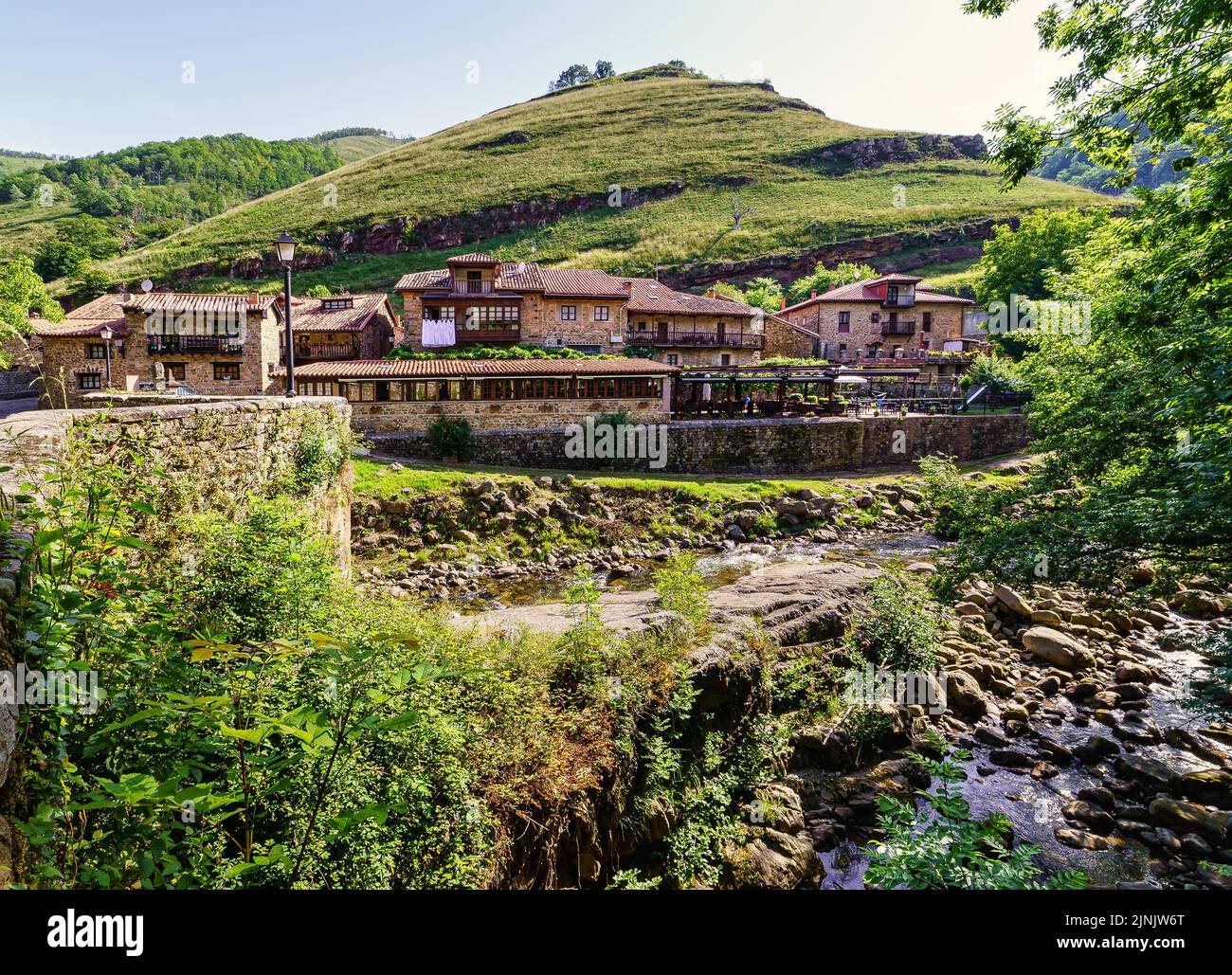 Stream passing next to an old mountain town. Barcena Mayor Santander ...