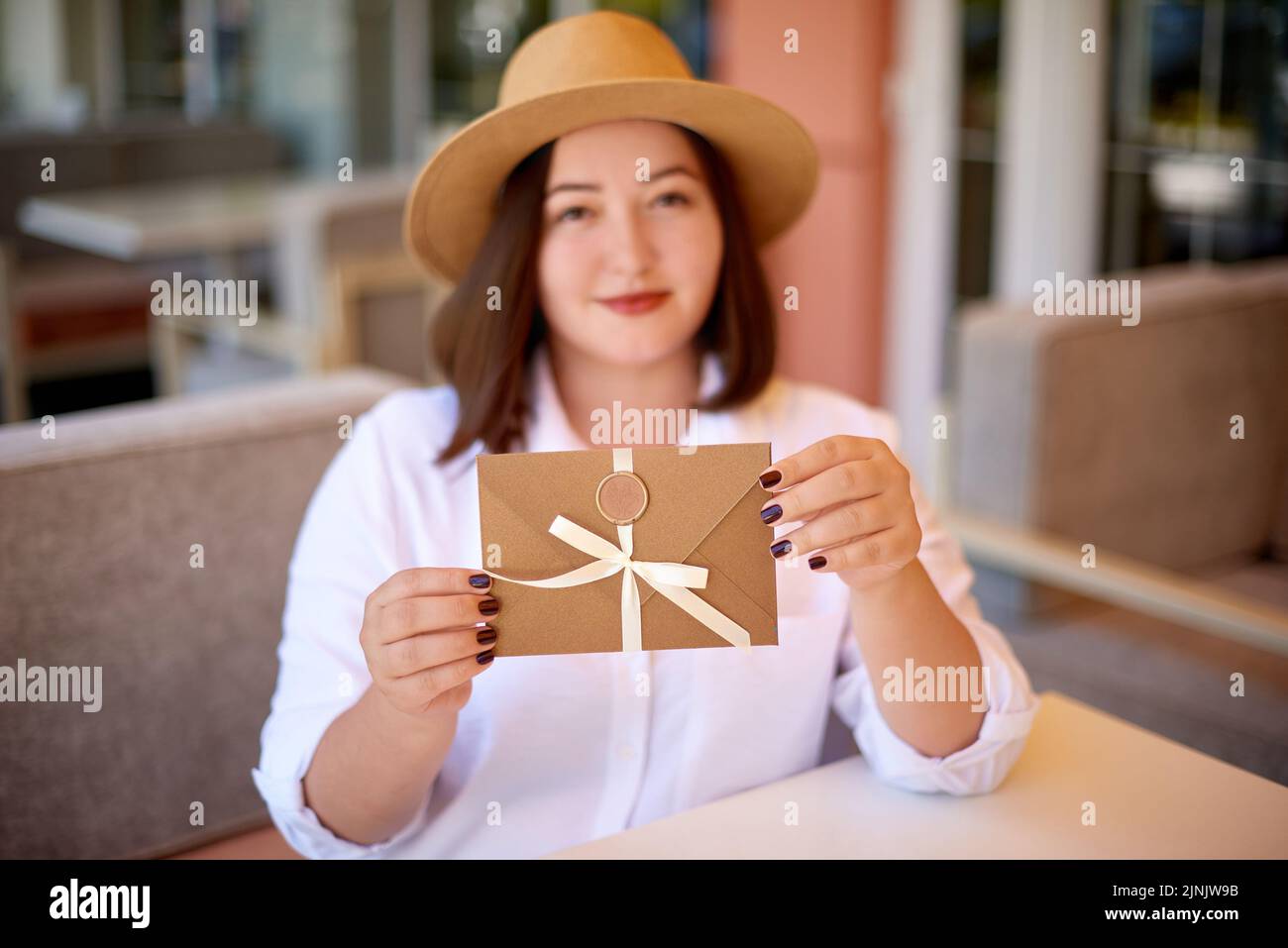 woman hold sealed envelopes. invitation envelope with ribbon and wax ...