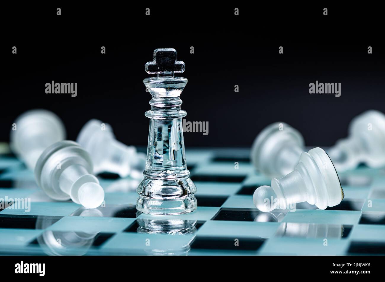 glass chess board game in black background ,selective focus on King ...