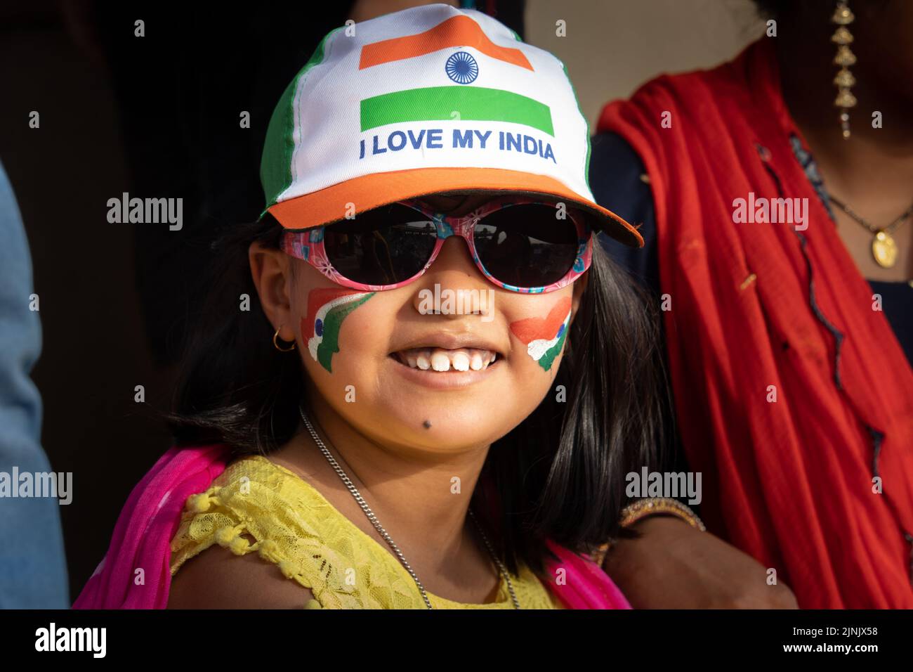 Portrait of an Indian girl child wearing tri-color cap and Indian flag ...