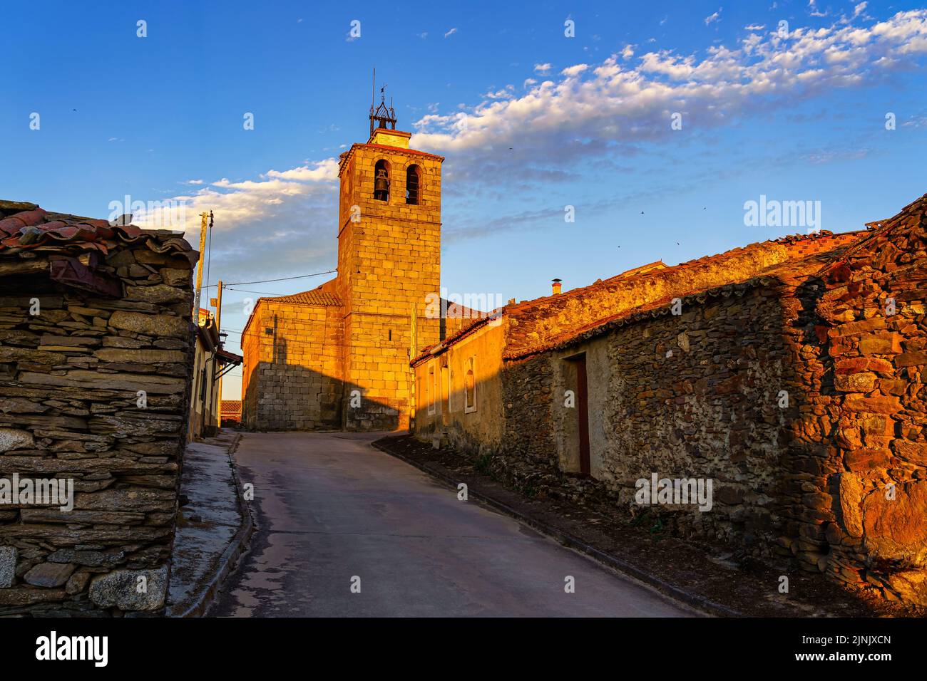 Old stone church with blue sky at sunset with old houses Stock Photo ...