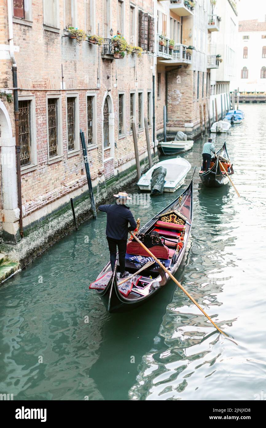 A vertical shot of a gondola ride on a channel in Venice, Italy Stock ...