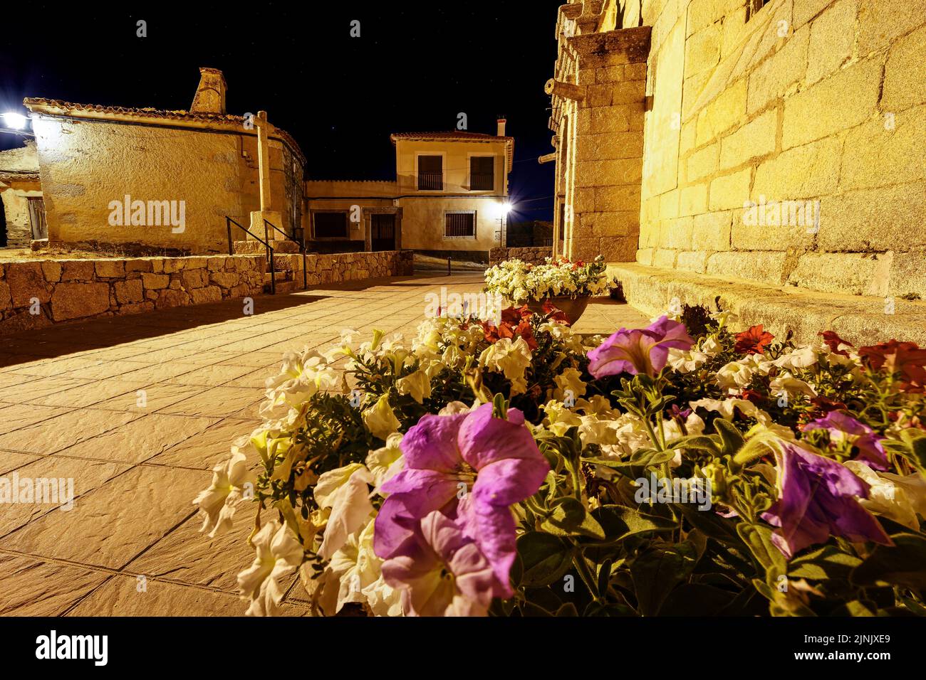 Romanesque church at night with flowerpots full of flowers Stock Photo ...