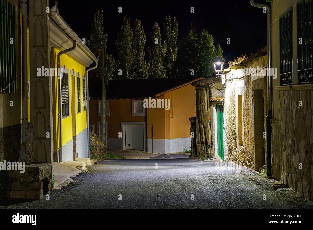Spanish village street at night with old stone houses Stock Photo - Alamy
