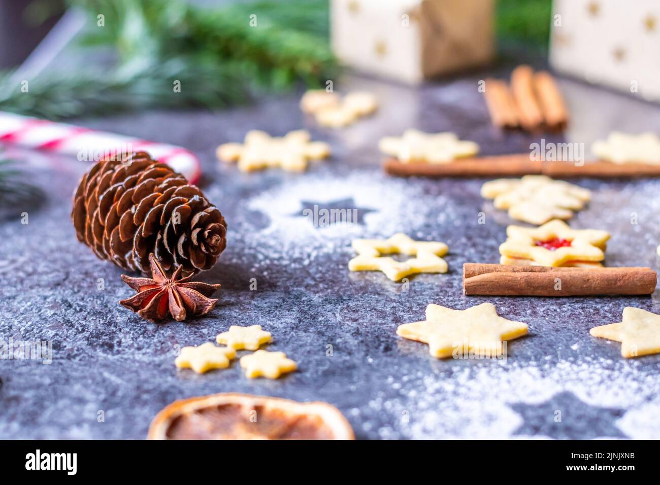 Christmas sweets and cookies placed on gray desk. Winter decorations ...