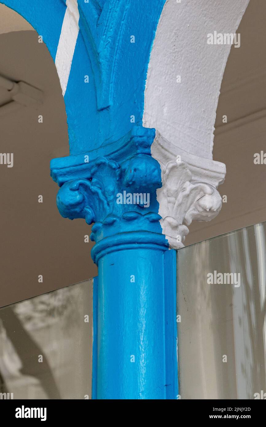 A view of the column of a white building with blue paint Stock Photo ...