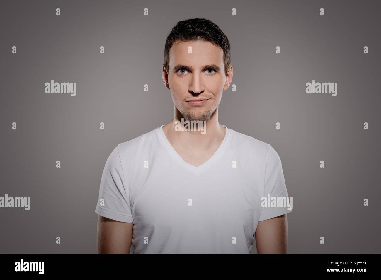 A man with an impish grin on his face while looking at the camera Stock ...