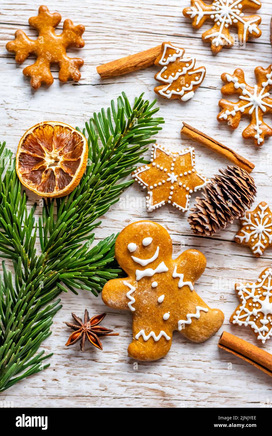 Christmas gingerbread and sweets are placed on wooden desk. Cookies and ...