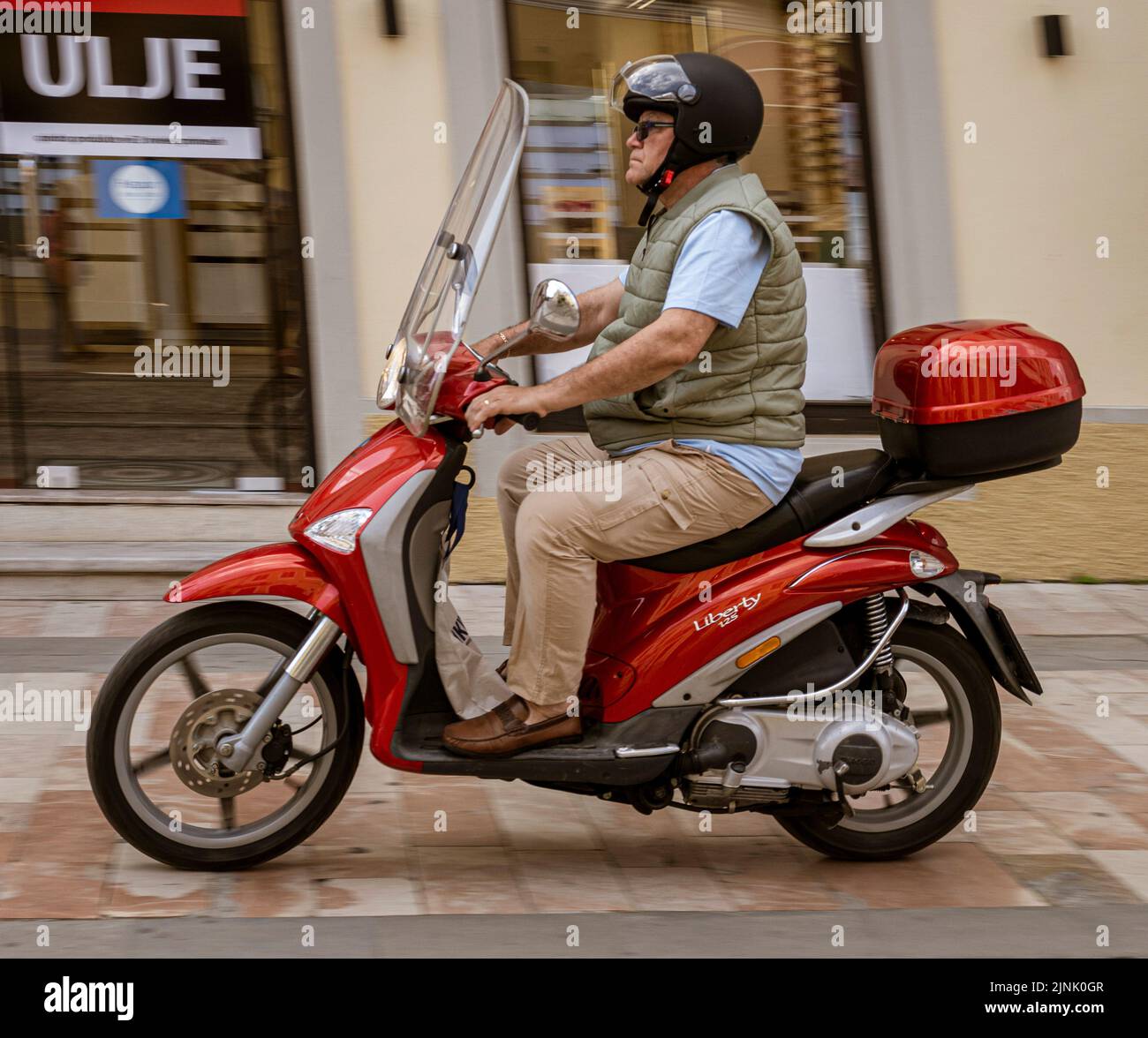 Albania, May 12, 2022 - man riding moped on street Stock Photo - Alamy