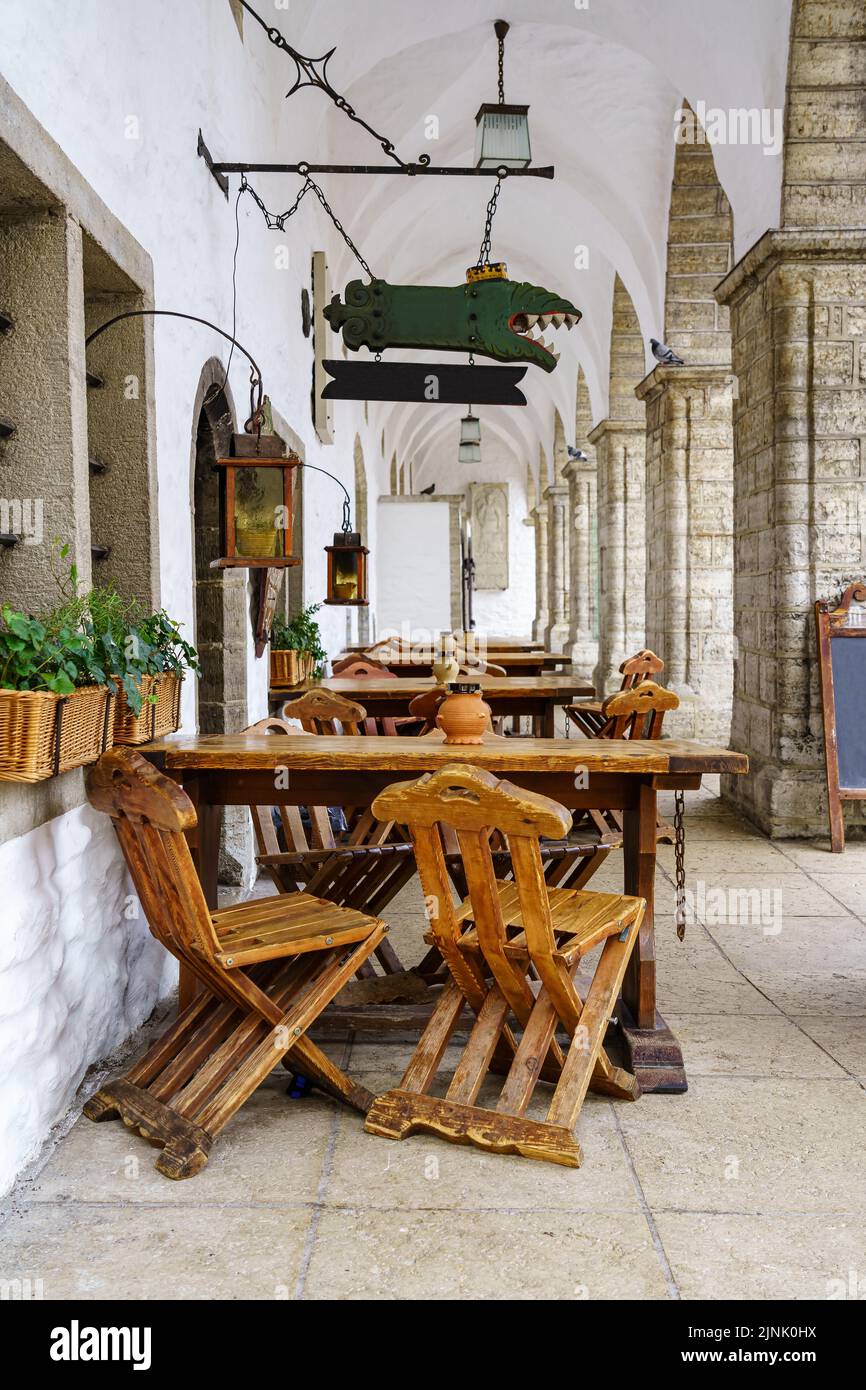 Wooden medieval tables and chairs in the city of Tallinn Estonia Stock ...