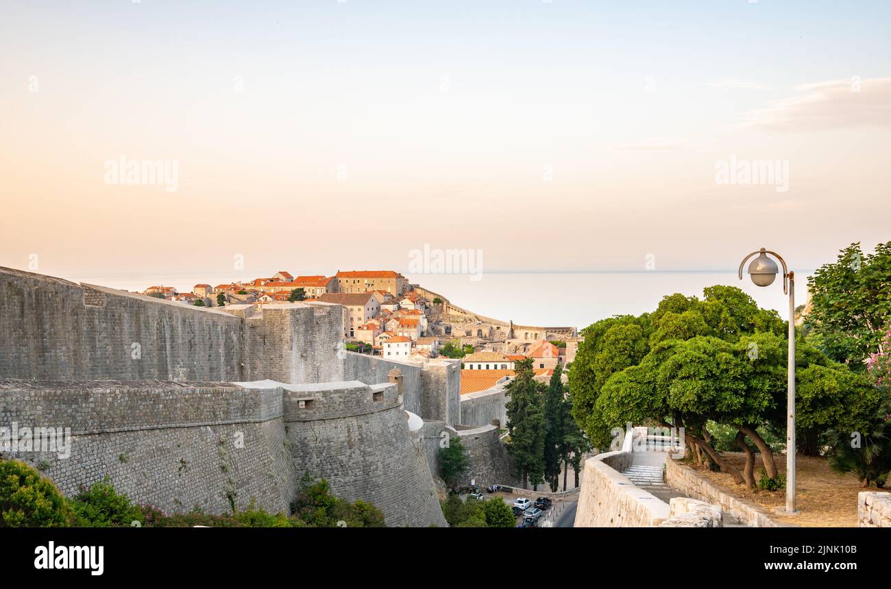 Panoramic view of sunrise over old town of Dubrovnik. Ancient city wall ...