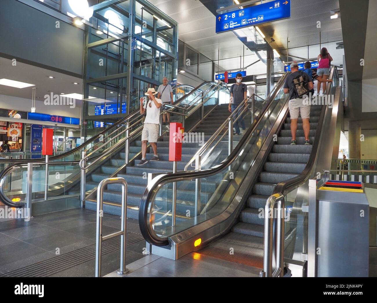 Passengers go up the escalator at Wels railway station Stock Photo - Alamy