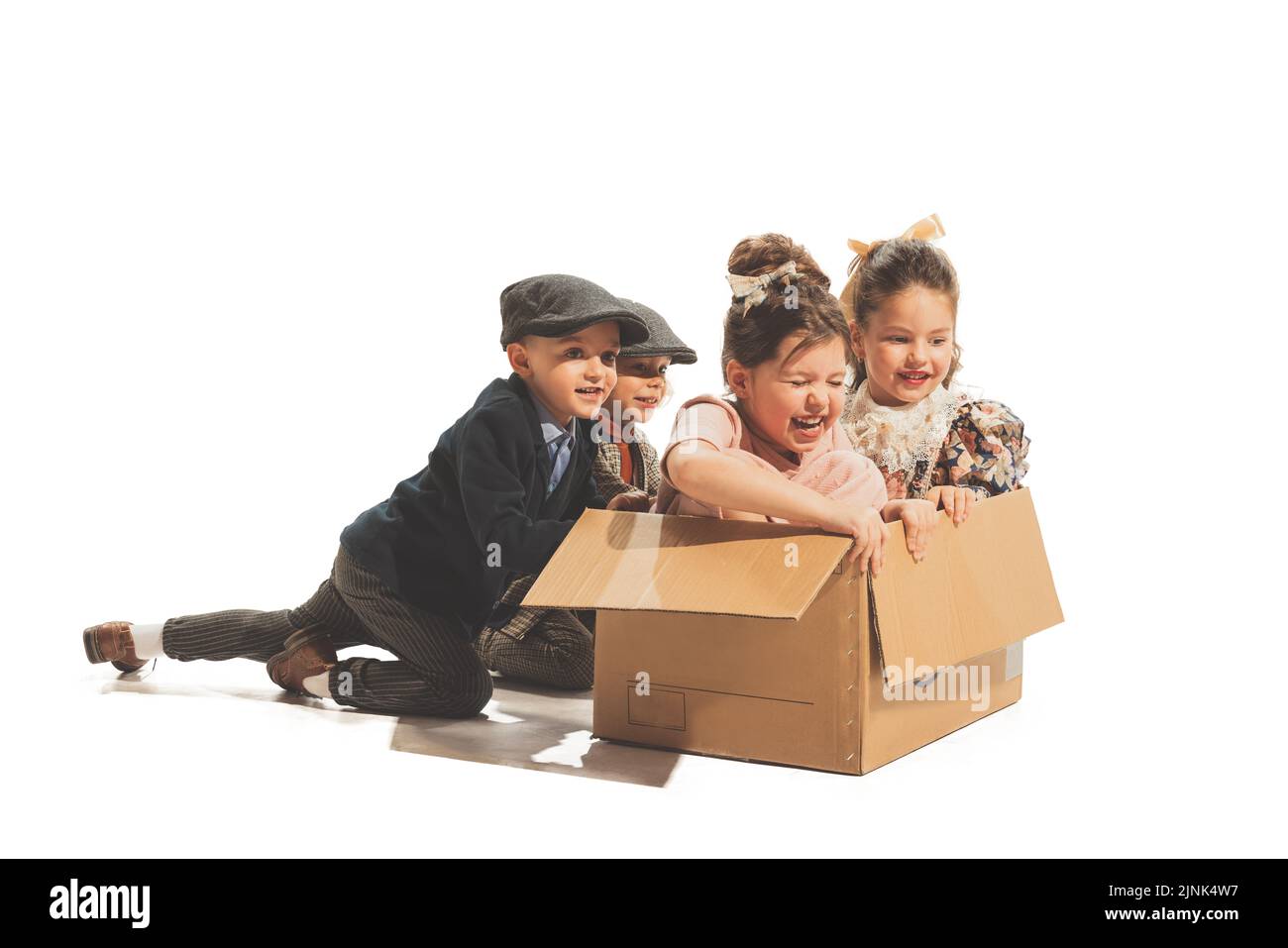 Group of happy children playing together isolated on white studio ...
