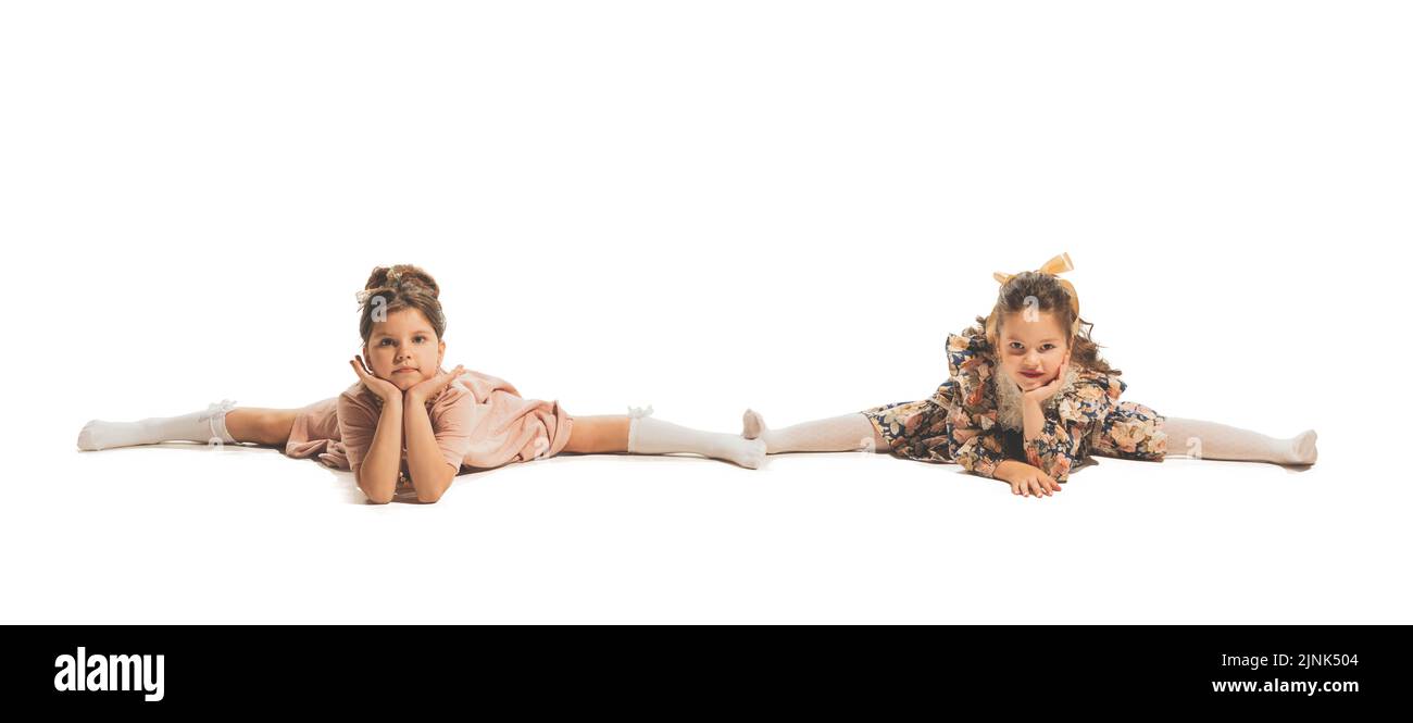 Cute happy little girls sitting in twine and looking at camera isolated ...