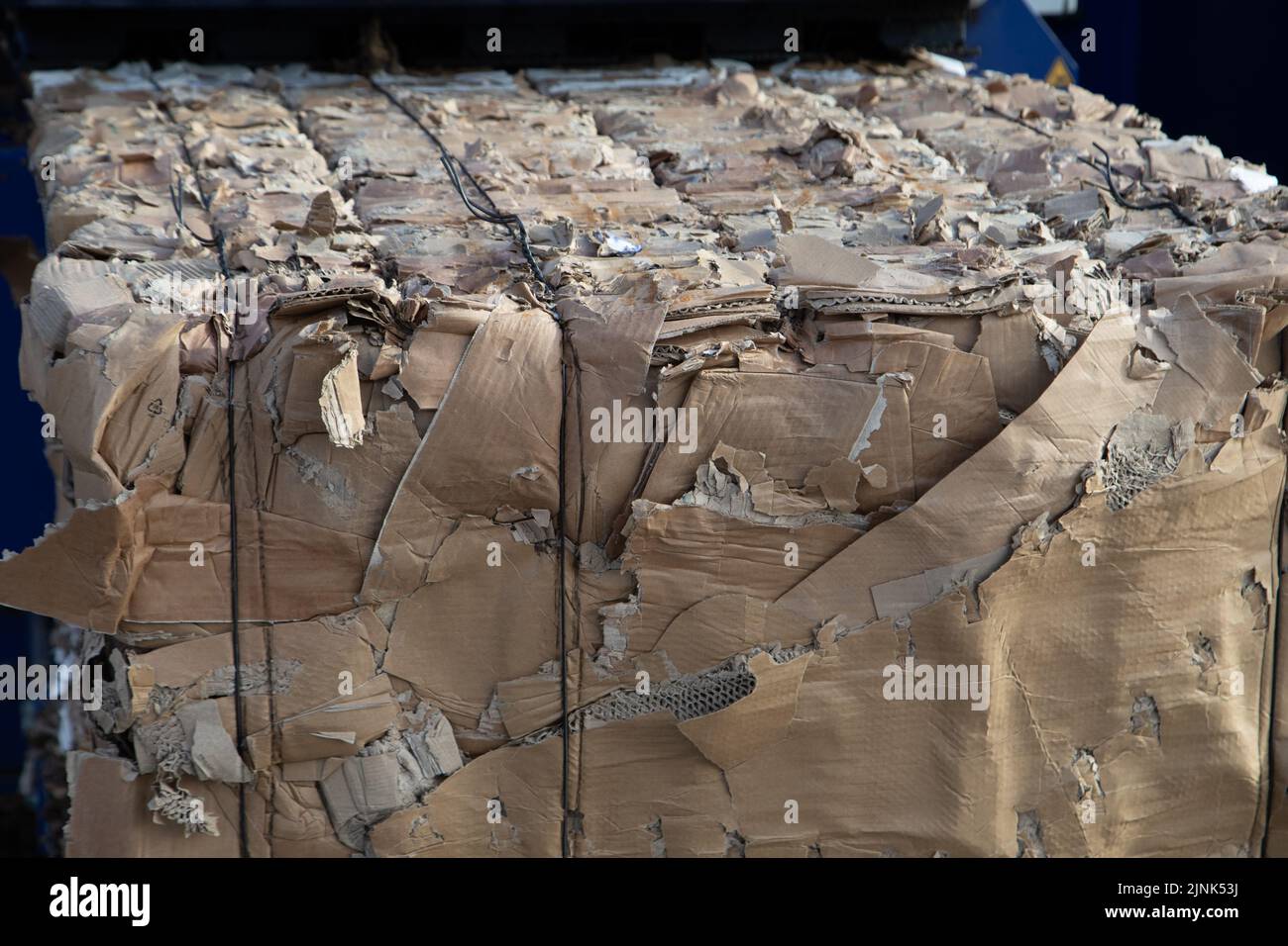 A closeup of pressed brown cardboard boxes ready to get recycled into a ...