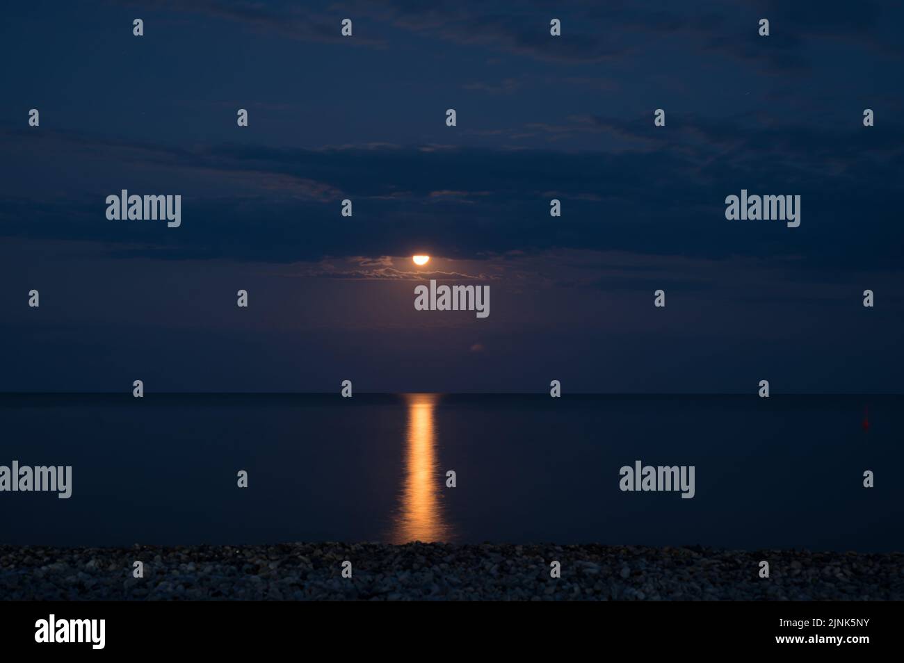 Night landscape. Full moon over the sea. Reflection of the moon path ...