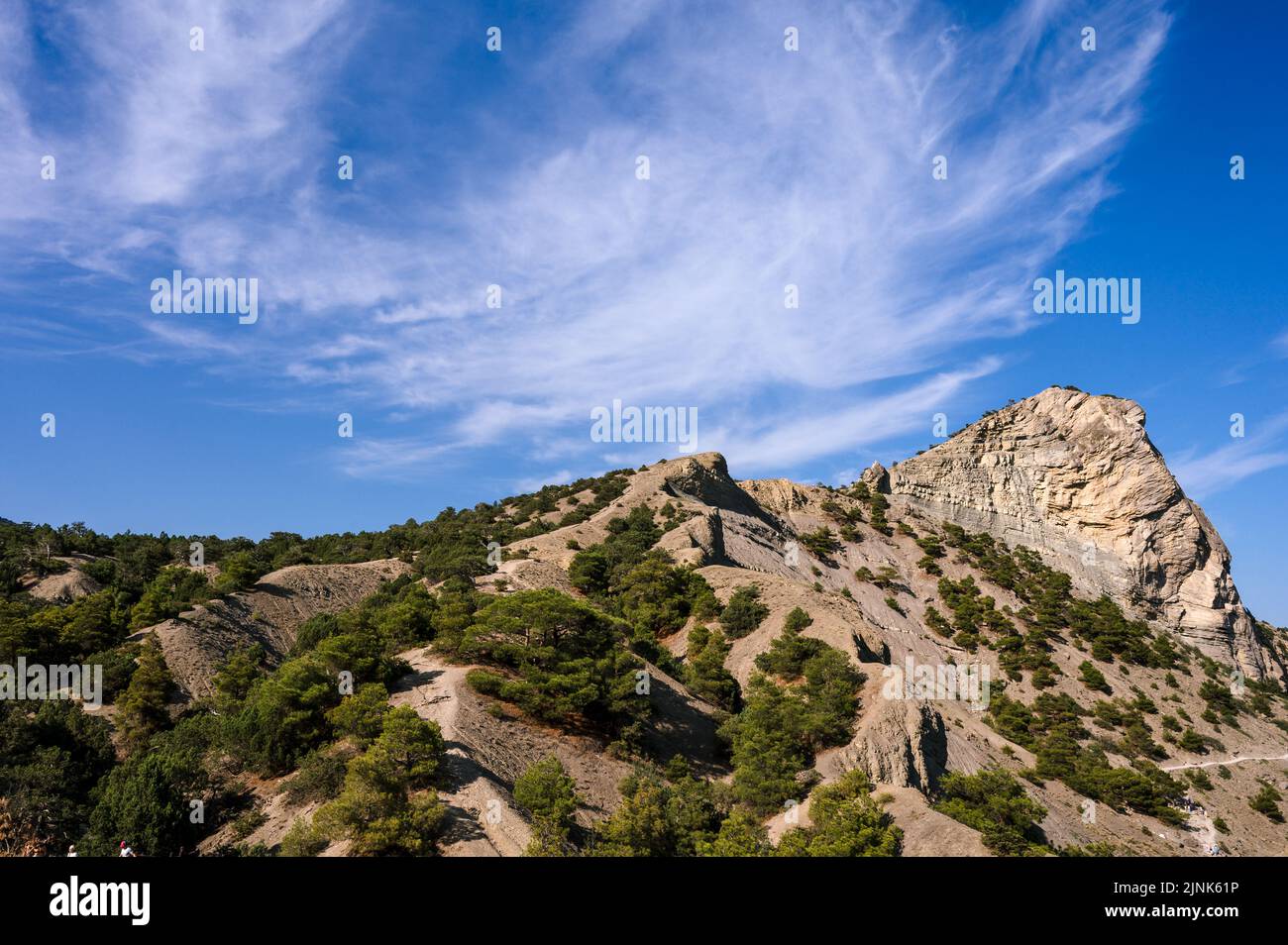 Bottom view of huge rock. Clouds in blue sea. Mountain Stock Photo - Alamy