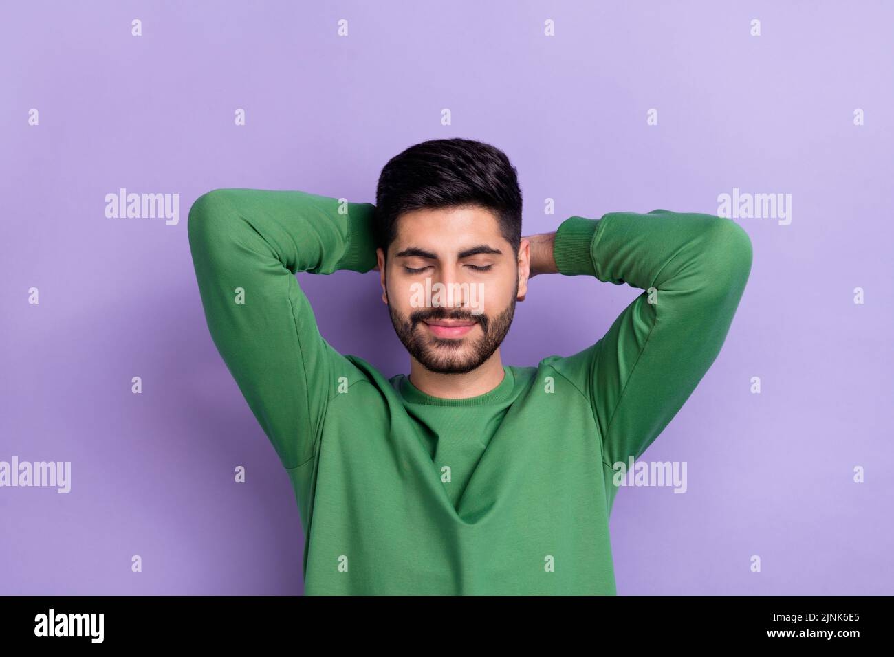 Photo of young handsome sleepy relaxed guy wear green pullover hold ...