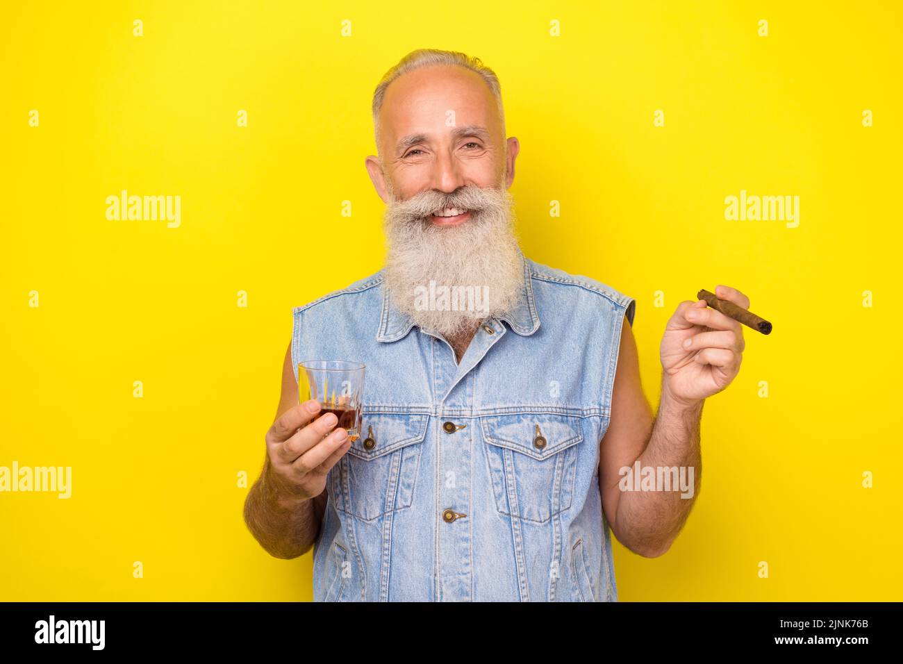 Photo of pretty handsome retired guy wear jeans waistcoat smoking ...