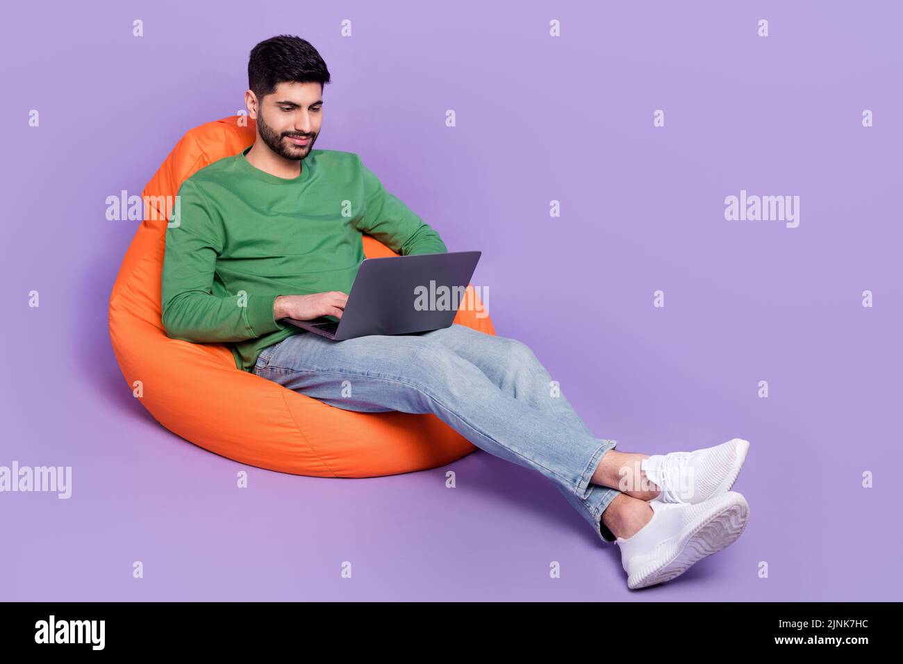 Full body photo of young latin guy sitting coding new software ...
