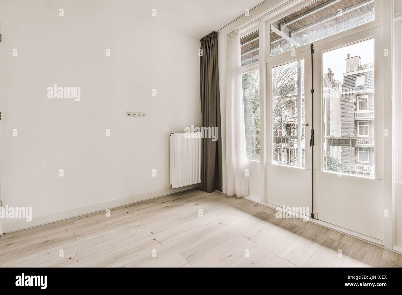 Modern cupboard and vintage chest placed near doors and wicker basket ...