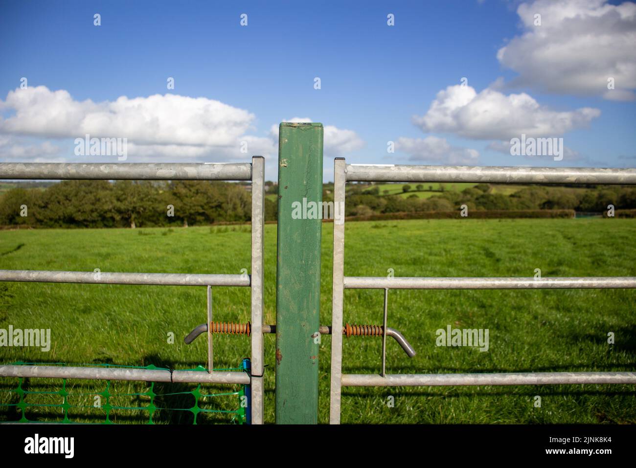green gate post and double gate with Devon countryside in the ...