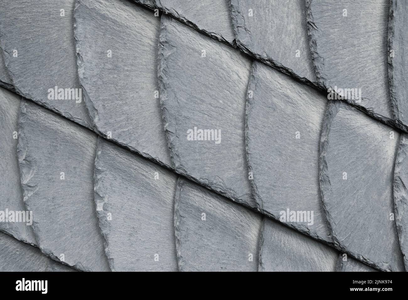 Detail close-up of natural grey stone shingle slate tiles texture roof ...