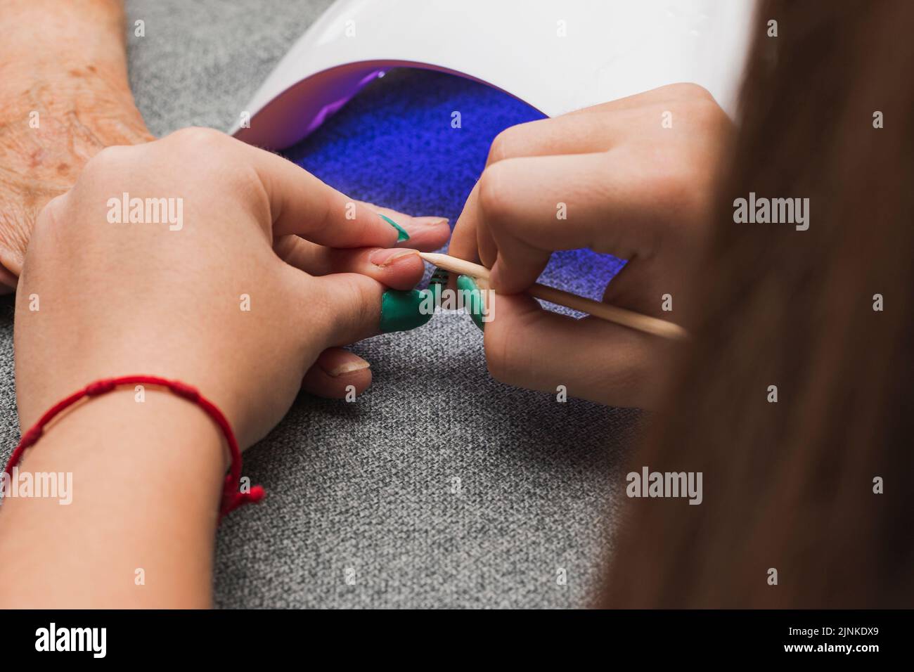 Woman having a manicure hair hi-res stock photography and images - Alamy