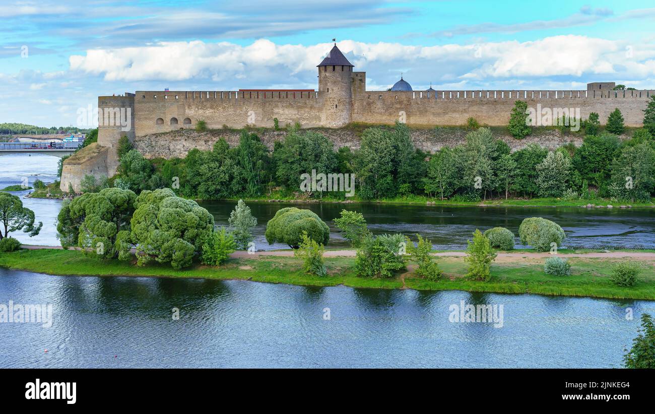 Medieval castle by the river with a great defensive wall and stone ...