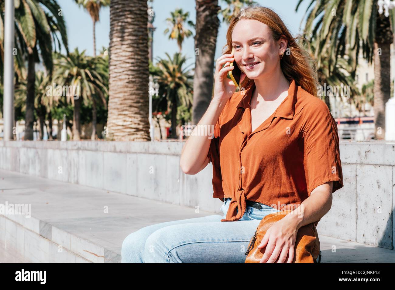 trendy woman taking by phone during holidays on her holidays ...