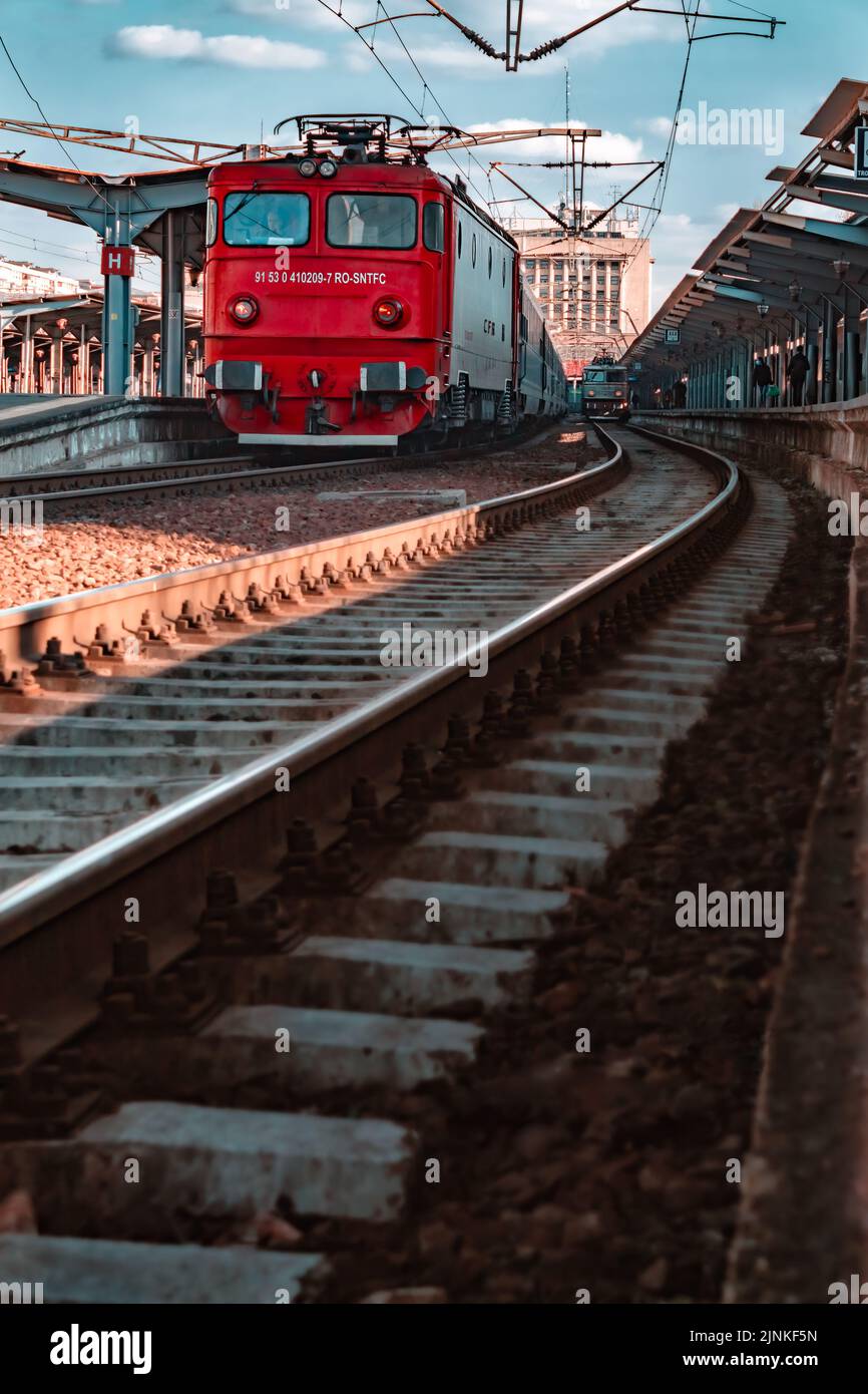 A vertical shot of a red train in North Railway station (Gara de Nord ...