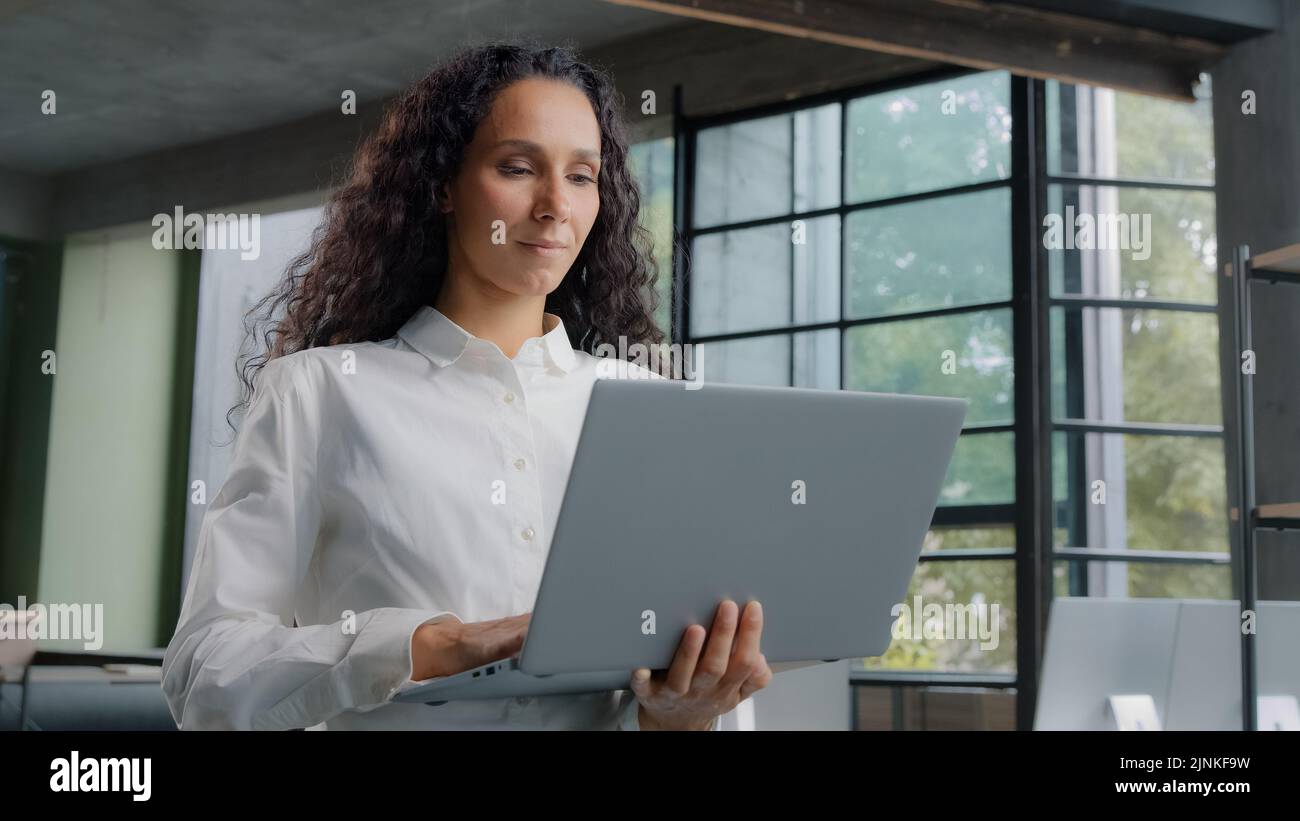 Successful businesswoman working in modern office typing on laptop ...
