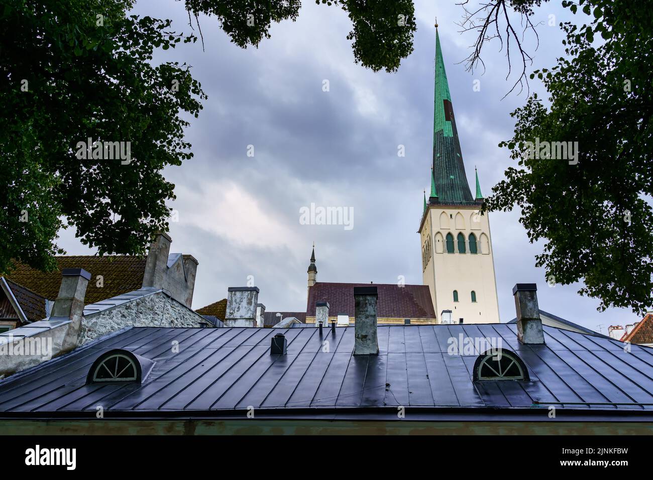 Medieval cathedral on rain-soaked rooftops in Tallinn Estonia Stock ...