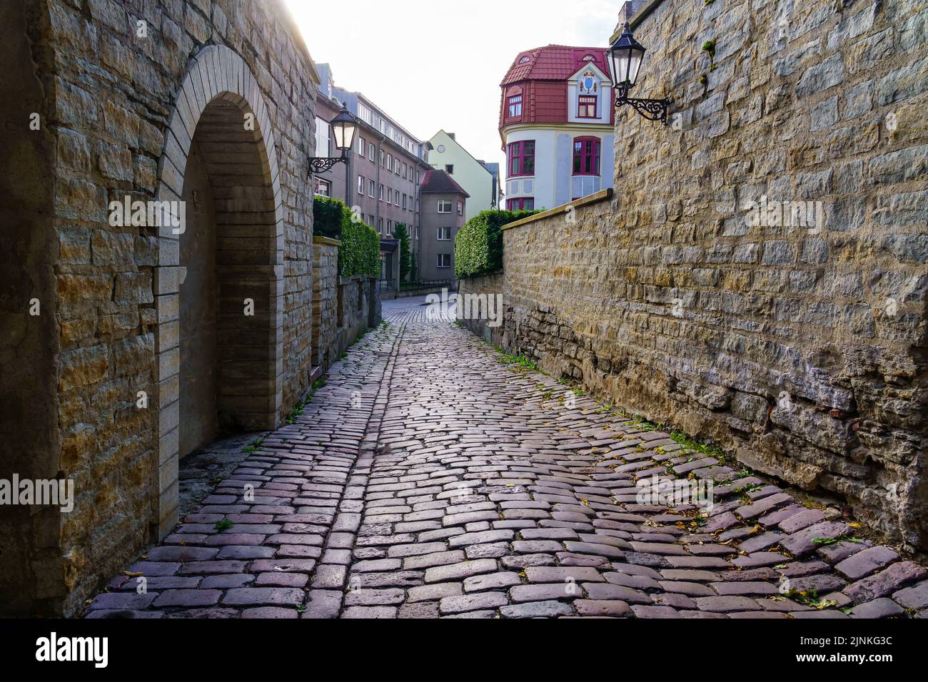 Medieval cobbled alley with arches and ancient stone wall. Tallinn ...