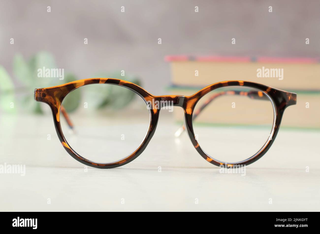 Stylish eyeglasses in leopard color on the desk Stock Photo - Alamy