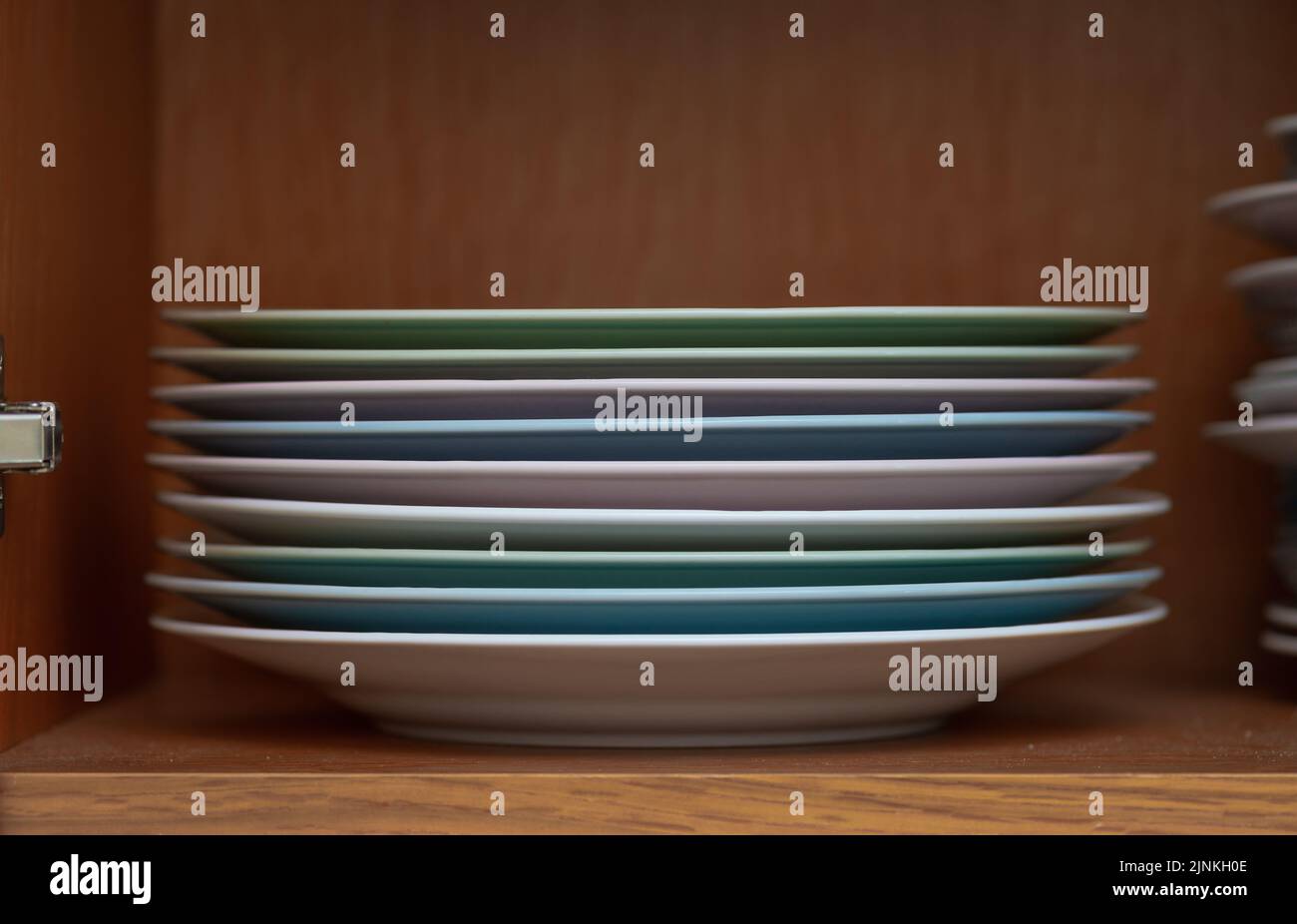 Stack of nine plates in multiple colors Stock Photo - Alamy