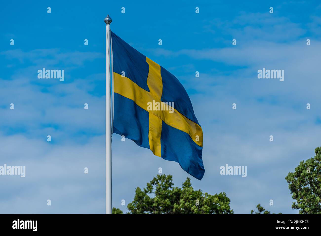 Swedish flag flying from a flag pole Stock Photo - Alamy