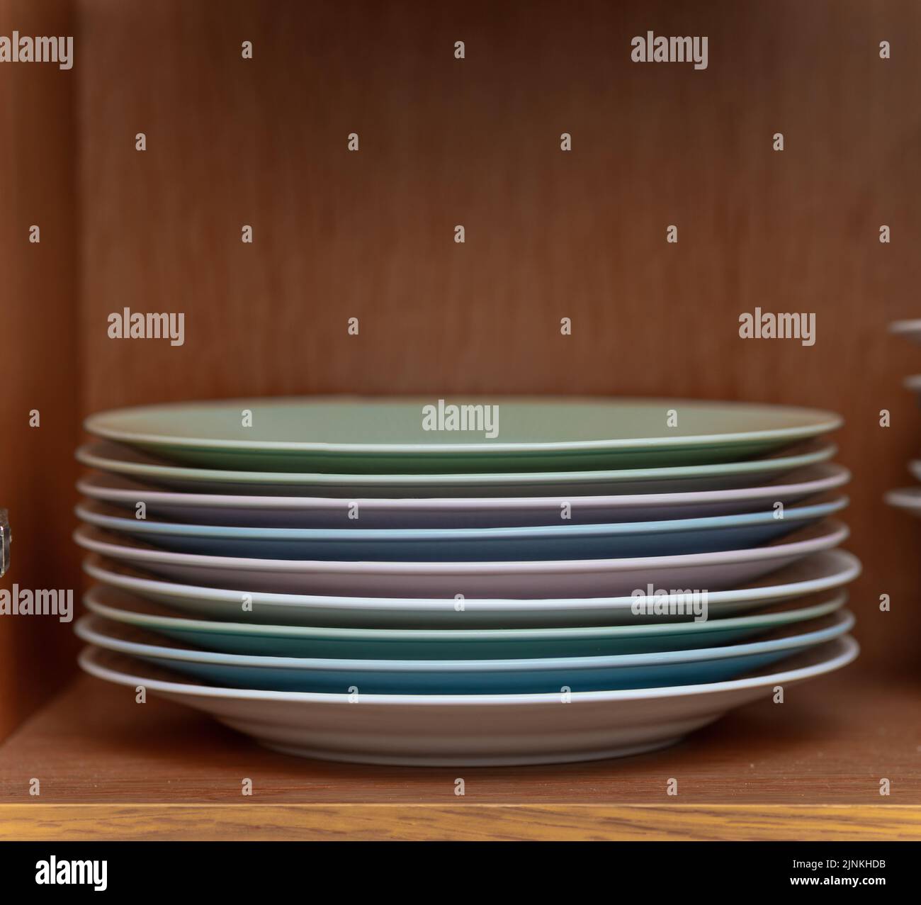 Stack of nine plates in multiple colors Stock Photo - Alamy