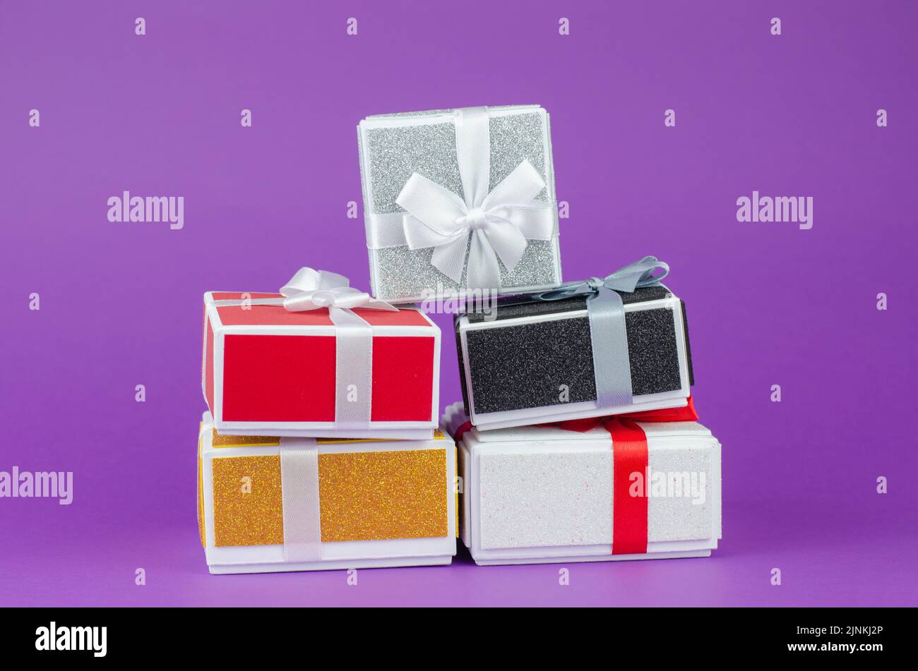 Large and small gift boxes on a purple background. Lots of gift boxes ...